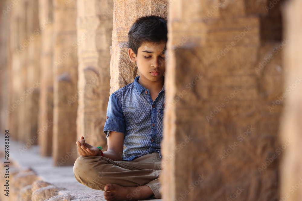 Indian young boy meditating at hindu temple Stock Photo | Adobe Stock