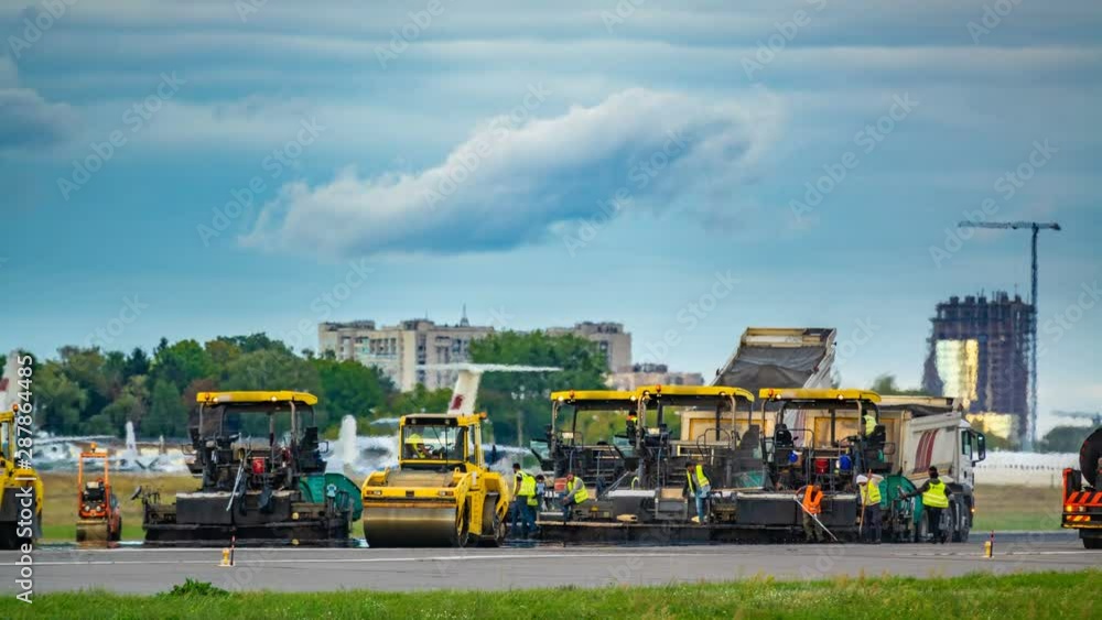 Airport runway repair. Road workers repairing the runway with paving ...