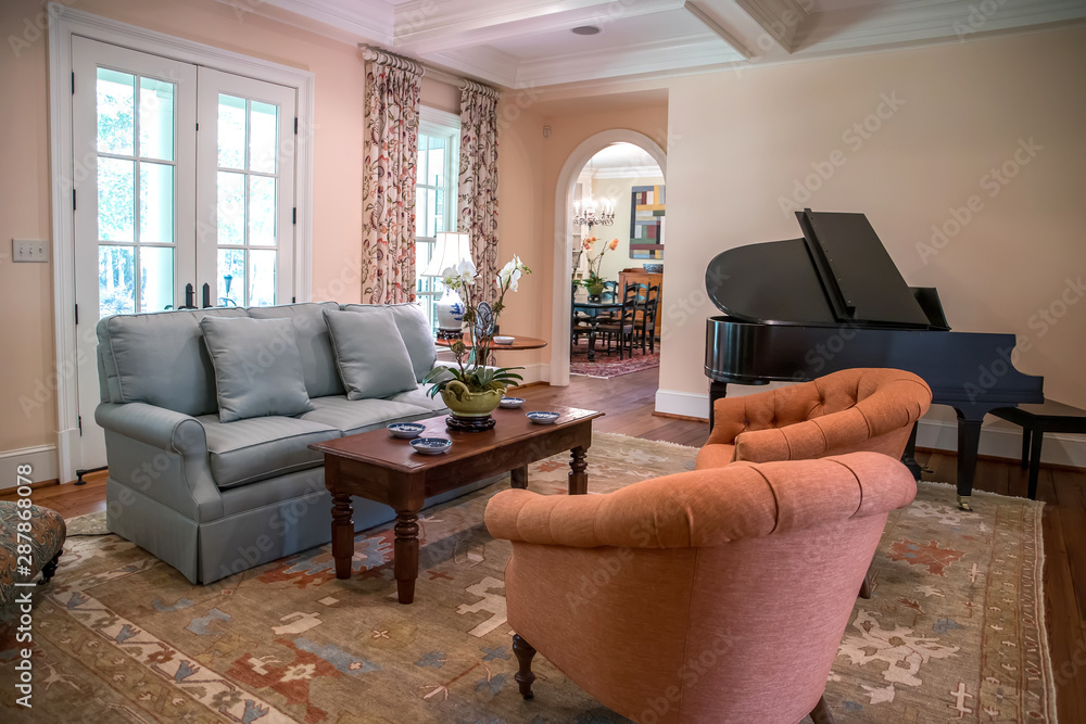 large formal living room in a spacious home. Arched doorway entrance ...