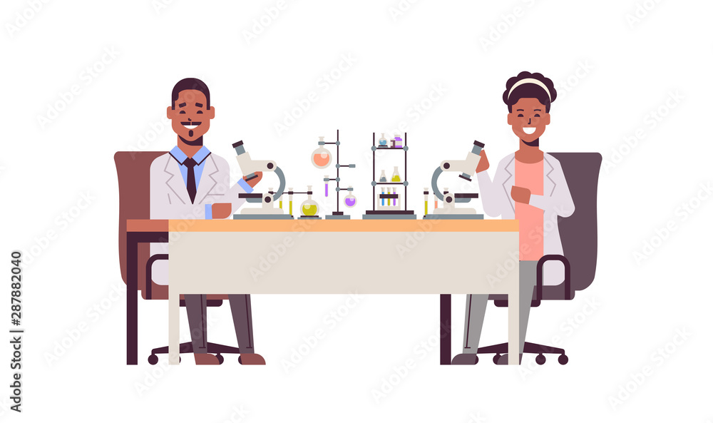 scientists couple using microscope african american man woman in ...
