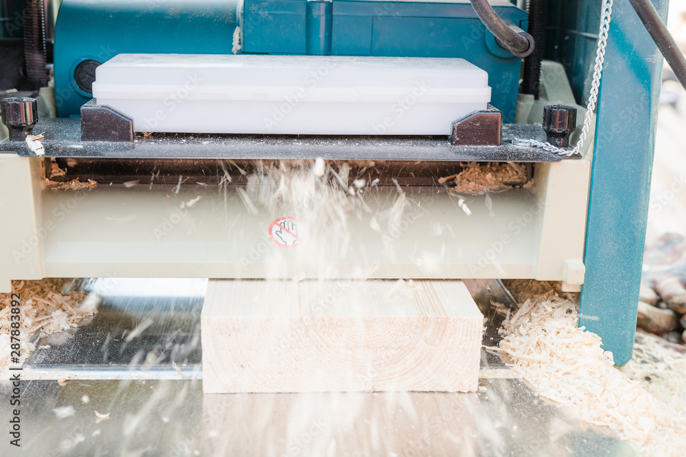 planing boards on a thicknesser. wood shavings. machine for planing ...