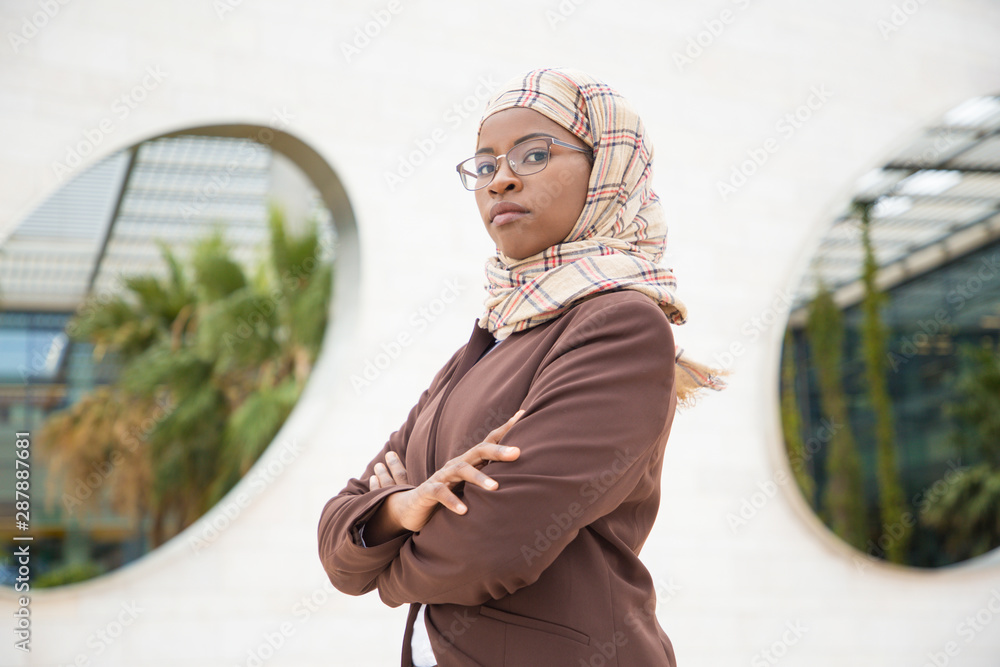 Proud Muslim female professional posing outside. Young dark skinned ...