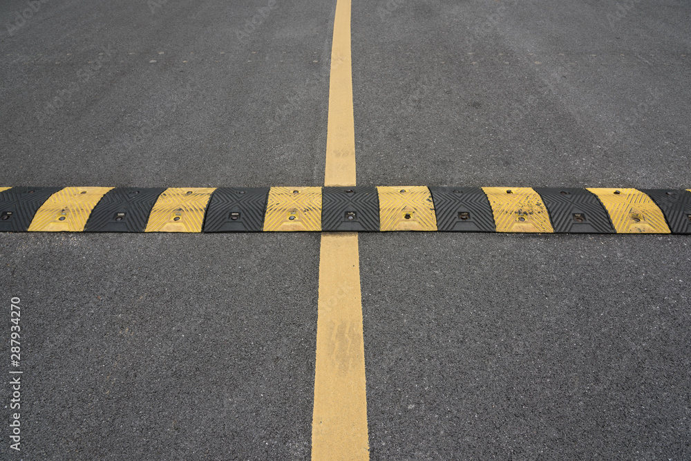 Yellow paint line and speed bump line on asphalt road Stock Photo ...