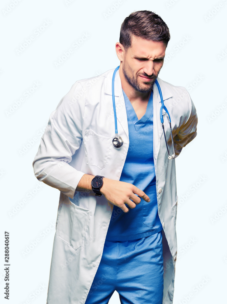 Handsome doctor man wearing medical uniform over isolated background ...