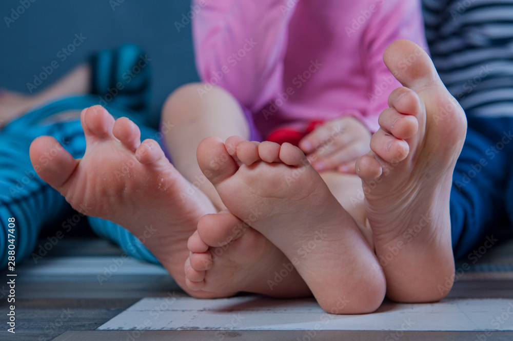 Three children are sitting on floor in room and are going to do ...
