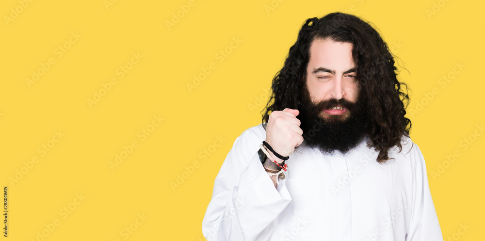 Man wearing Jesus Christ costume angry and mad raising fist frustrated ...