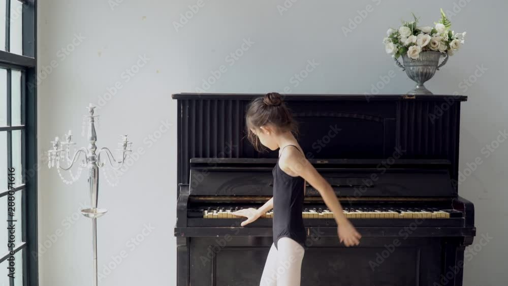 4K Tracking shot happy little child girl dancer in black leotard and ...