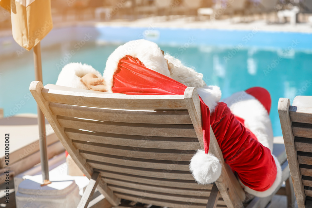 Foto de Santa Claus resting near swimming pool at resort do Stock ...