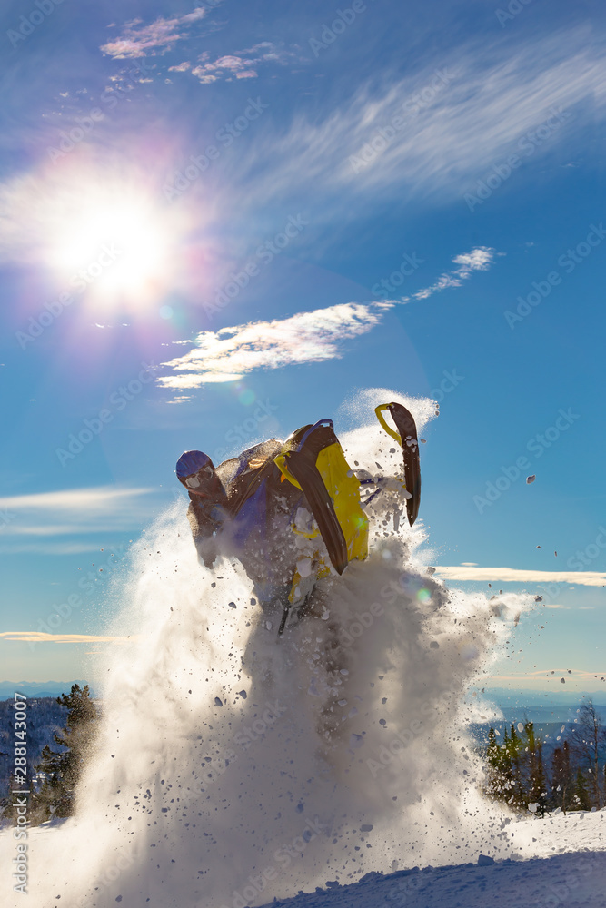 snowmobile jump. bright snowmobile in motion. the guy is flying on a ...