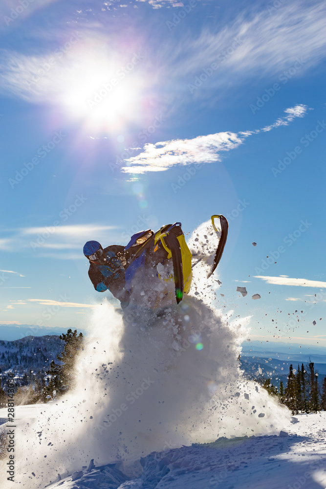 snowmobile jump. bright snowmobile in motion. the guy is flying on a ...