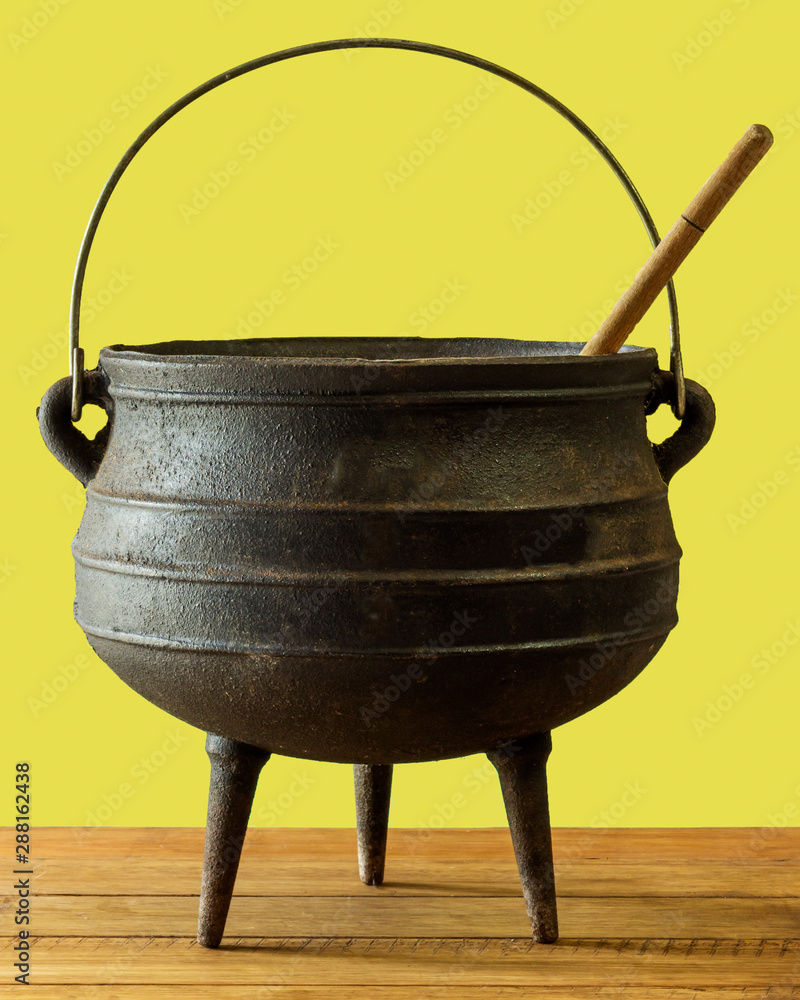 cast iron pot (south african potjie pot) with wooden spoon Stock Photo ...