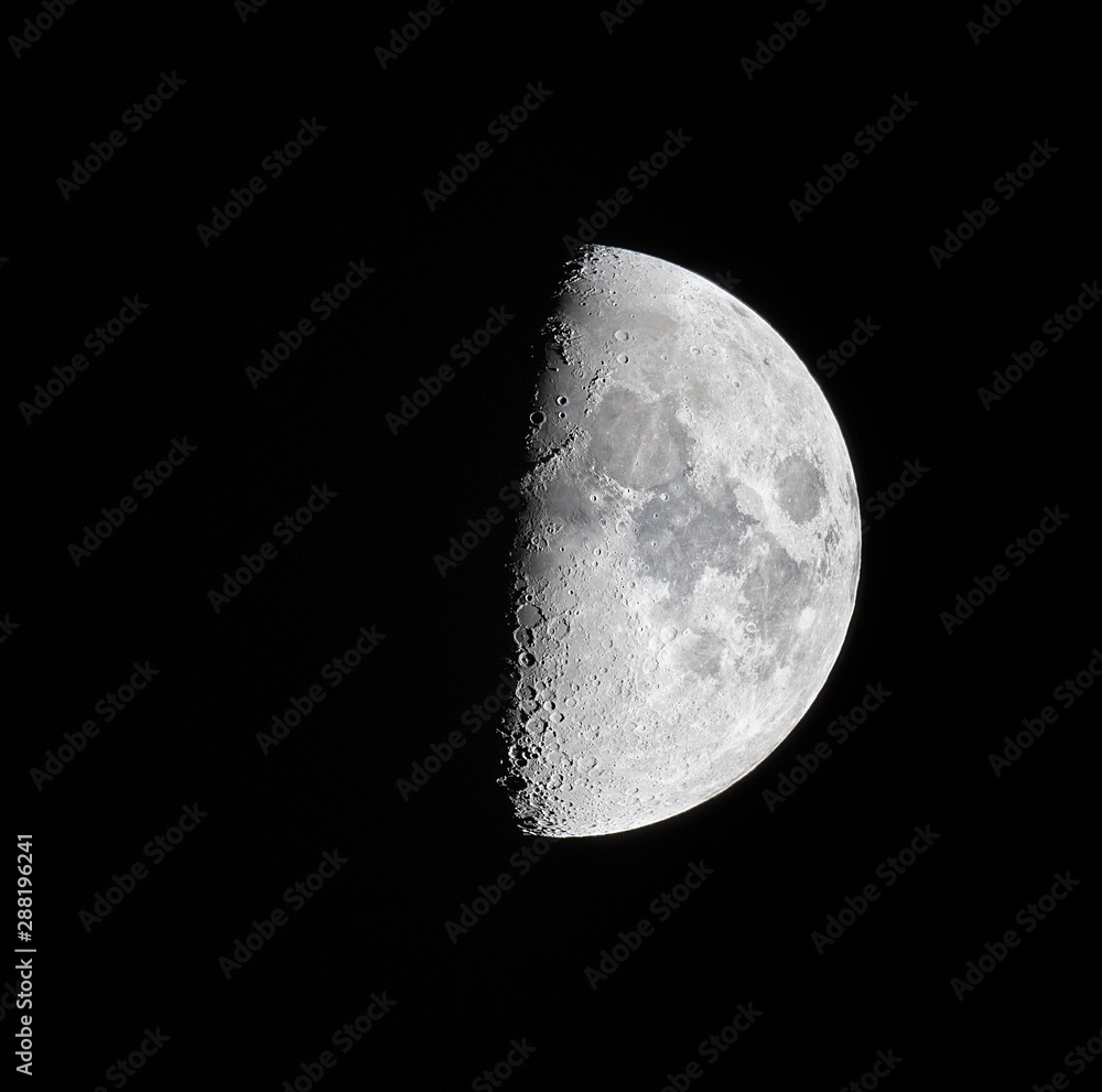 The half moon and its craters. Stock Photo | Adobe Stock