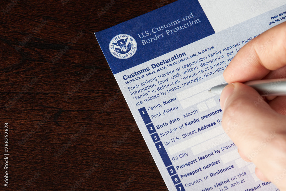Filling up us customs declaration form ภาพถ่ายสต็อก | Adobe Stock