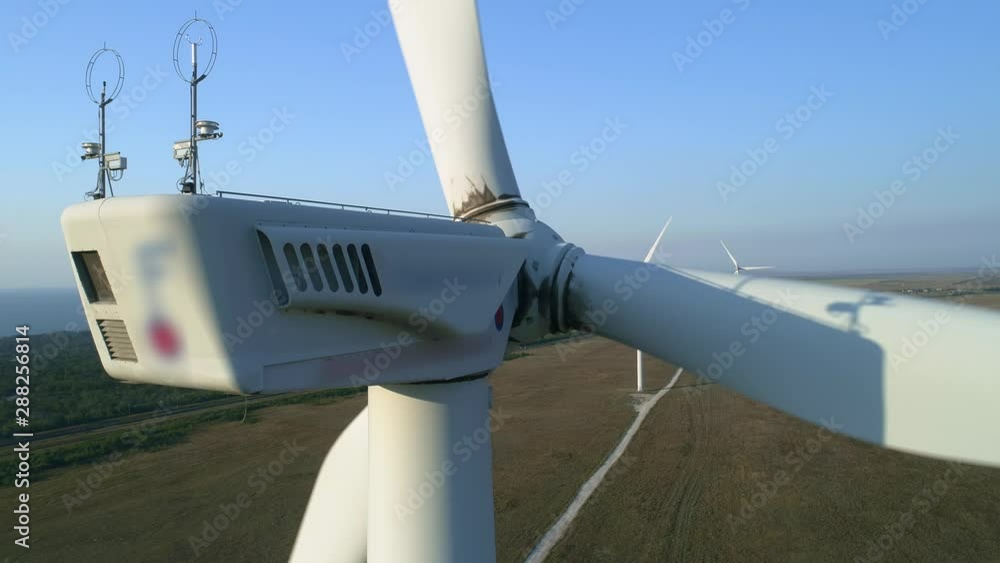 Close up of a wind turbine. Aerial top view wind turbine, moving above ...