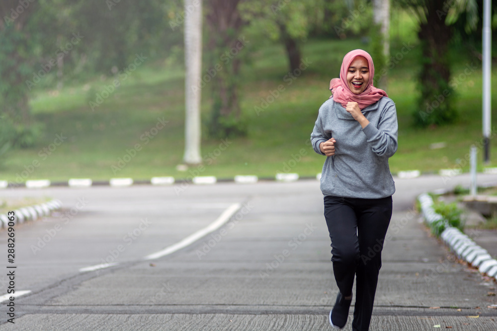 portrait of muslim young woman doing exercise outdoor Stock Photo ...
