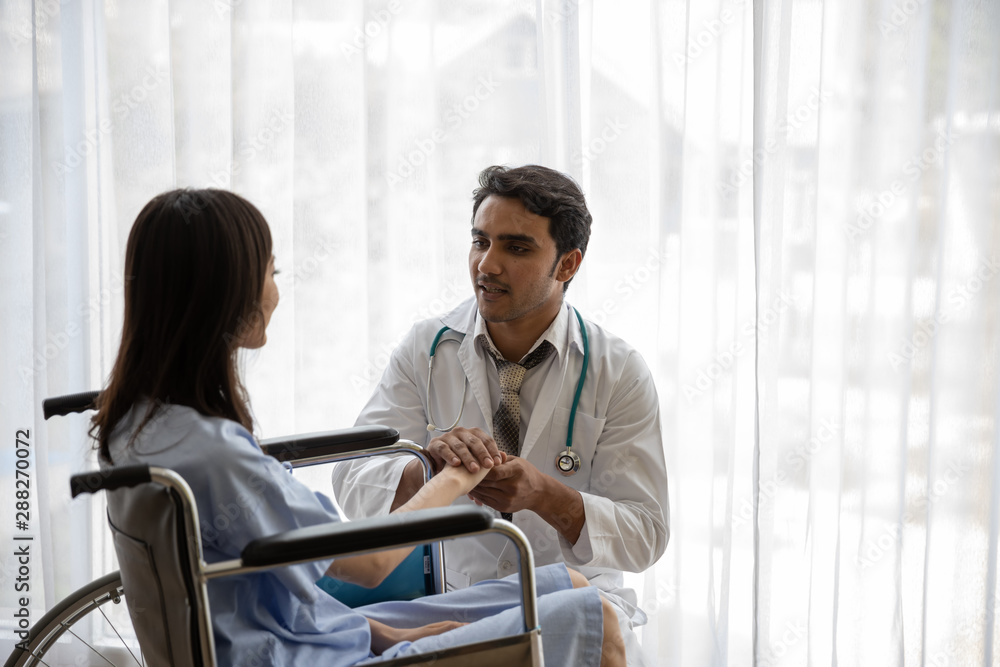 Doctor Touching hands Asian woman patient on wheelchair in hospital ...