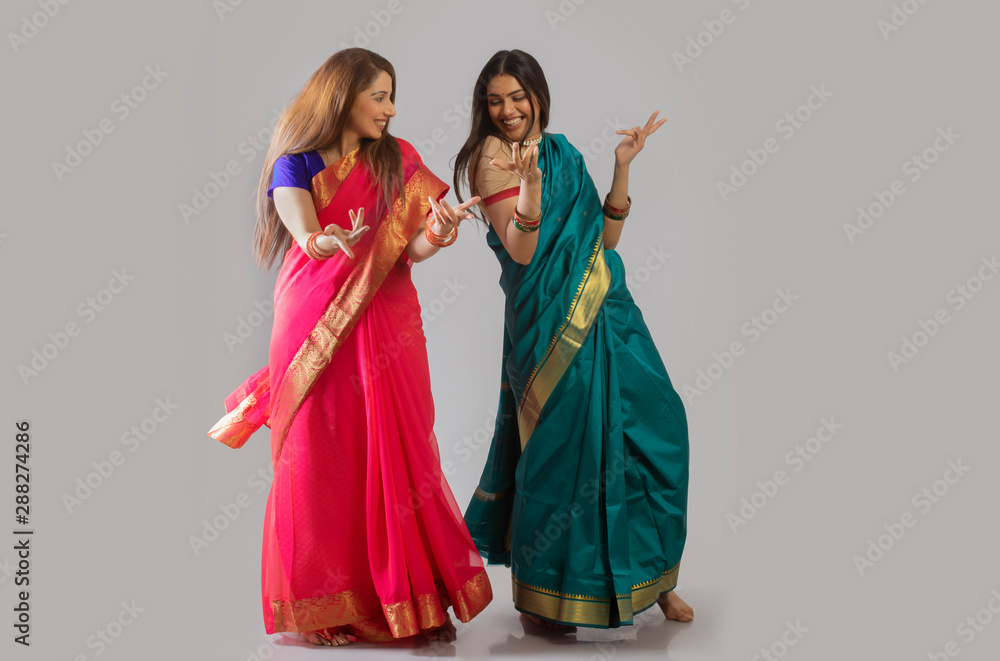 young women dancing in saree Stock Photo | Adobe Stock