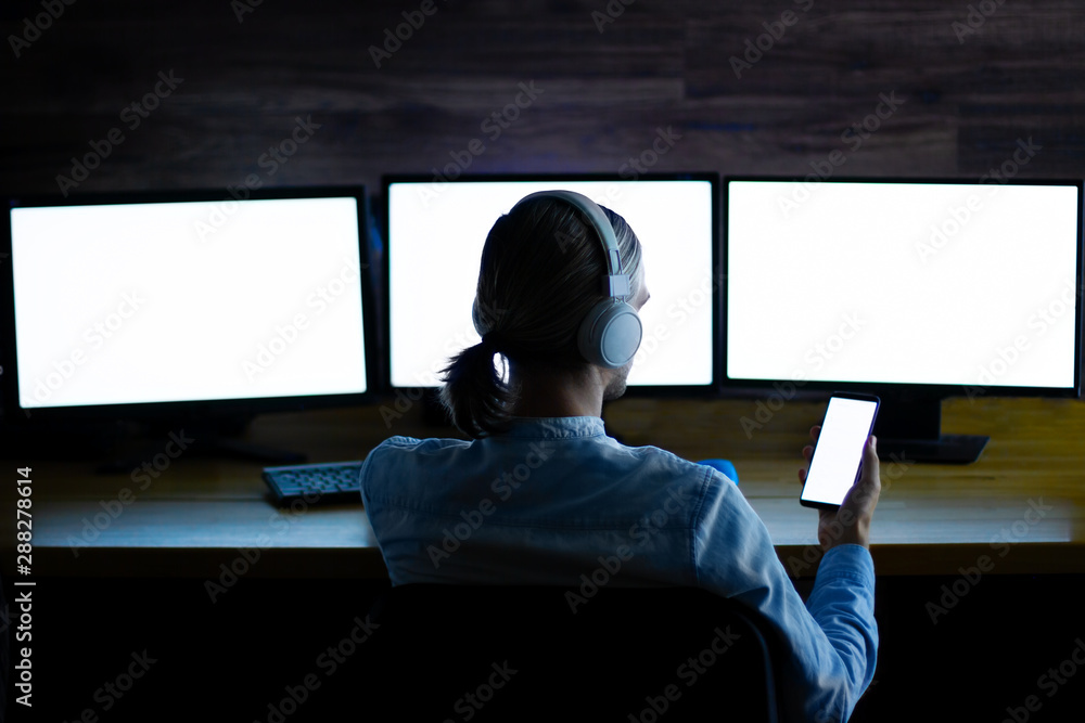 Software developer, freelancer, designer with white headphones working ...