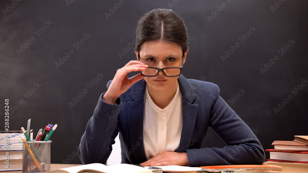 Angry teacher looking aggressively to camera taking off glasses, strict ...