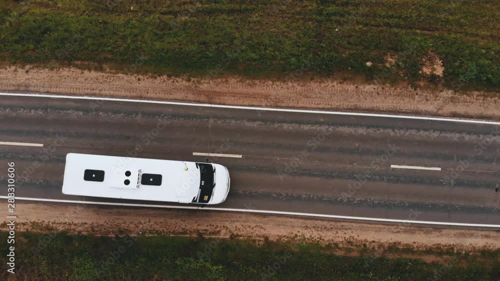 white bus drives along asphalt road with marking aerial Stock Video ...