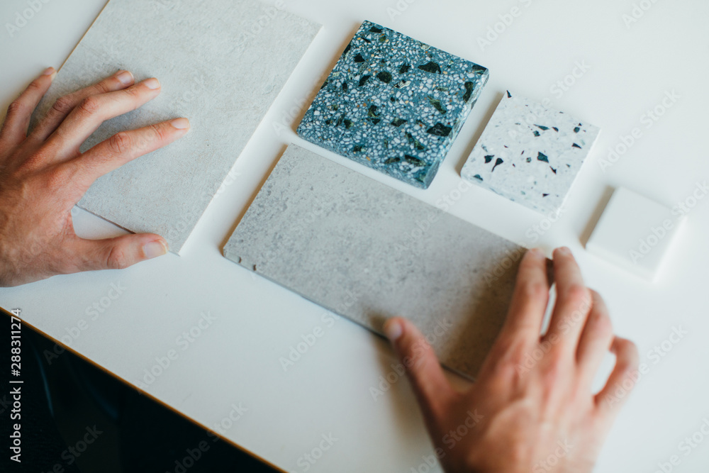 Architect is demonstrating different samples of materials. Hands only ...