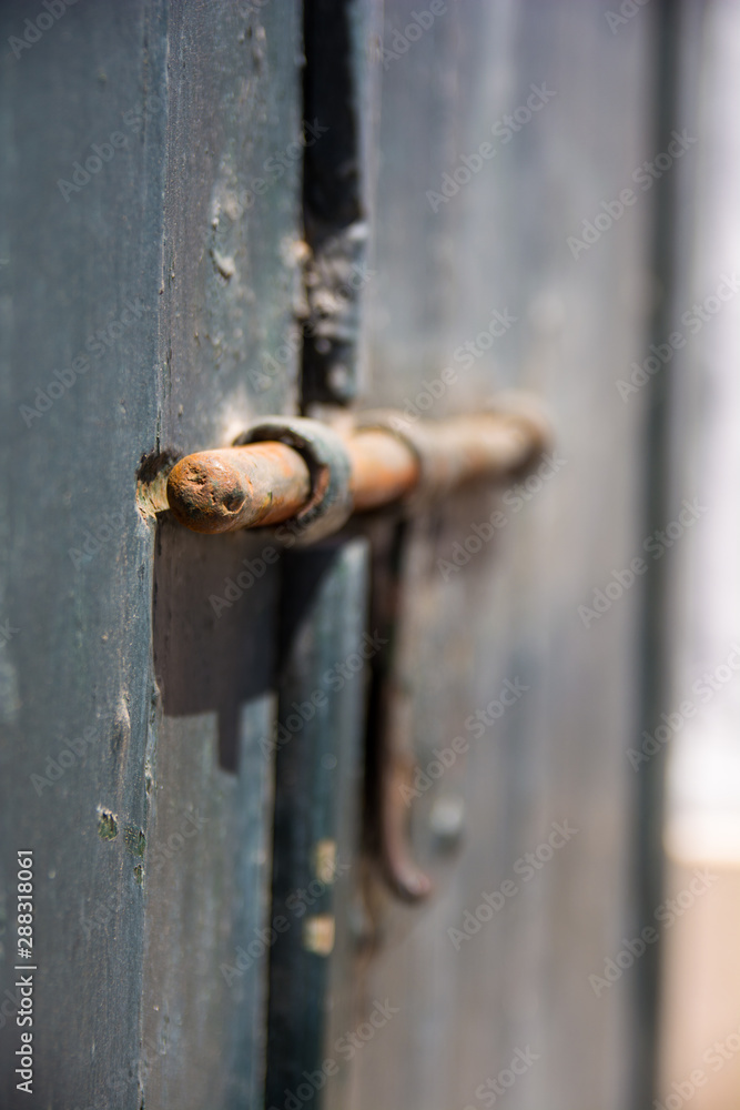 Rusty old slide bolt or tower bolt on a worn green door. Stock Photo ...