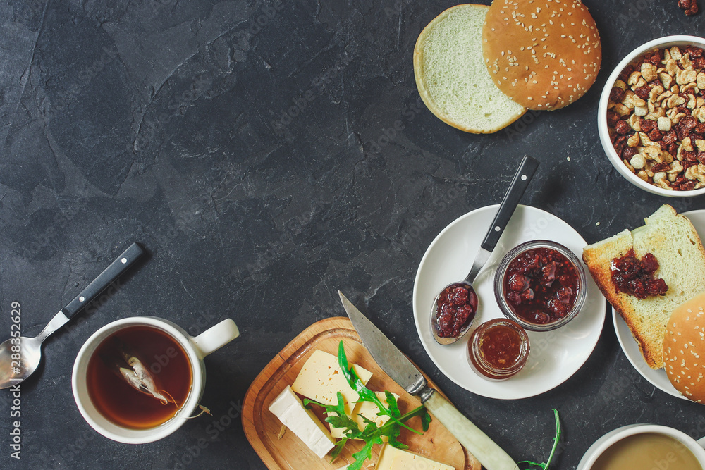 table with morning food, breakfast (tea, coffee, jam, toast, sandwich ...