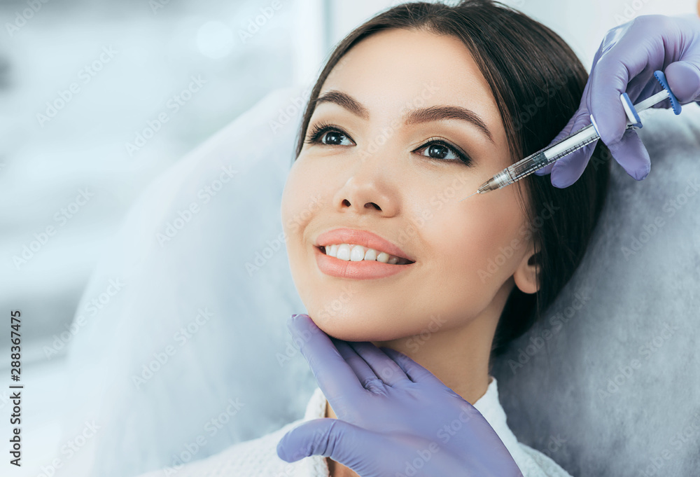 Korean woman getting rejuvenation injection for fresh skin. Staying ...