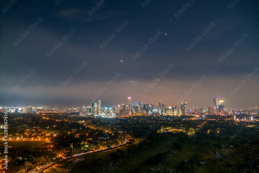 Skyline of Manila, Philippines, during night, with the big city lights ...