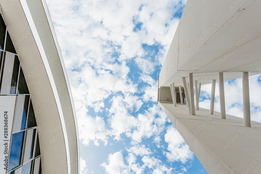 Photograph of a tower with a bell tower and a church window in modern ...