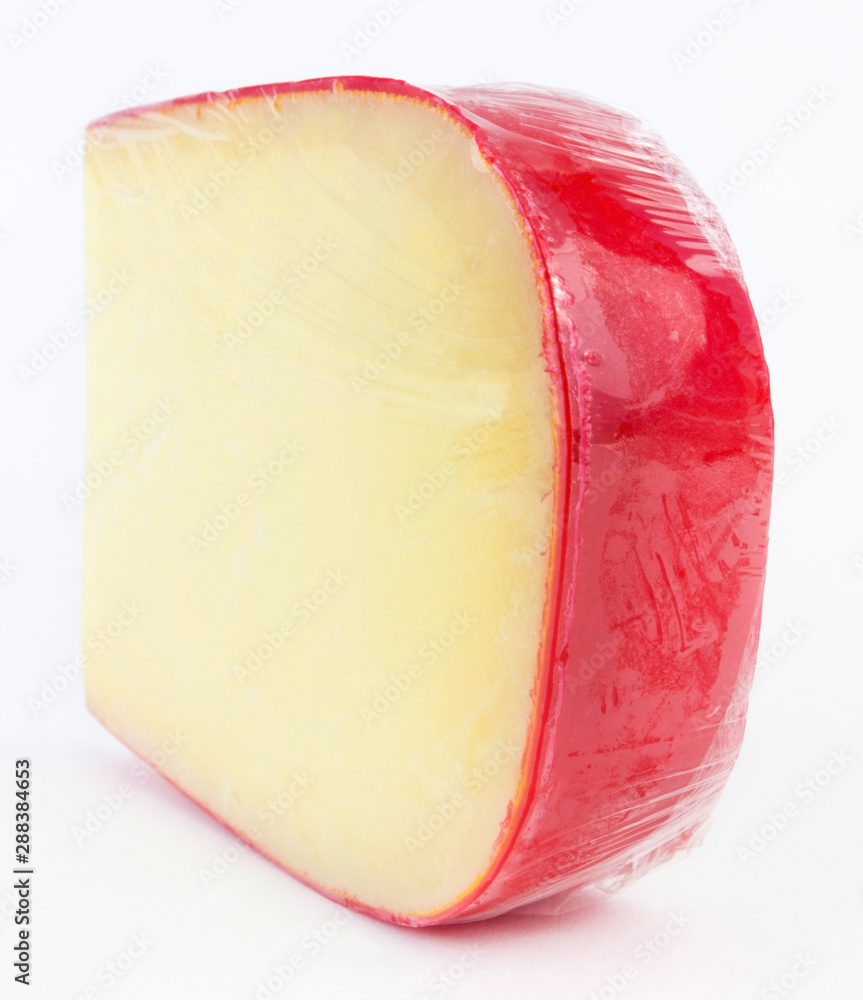 Isolated wedge of Dutch red wax gouda cheese wrapped in plastic ...