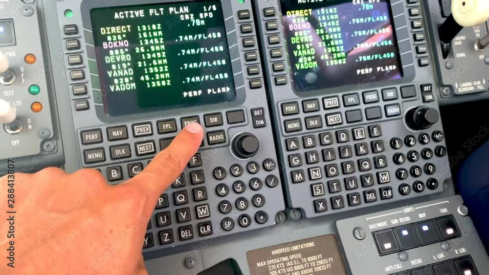 Closeup view of a pilot checking the flight management system to verify ...