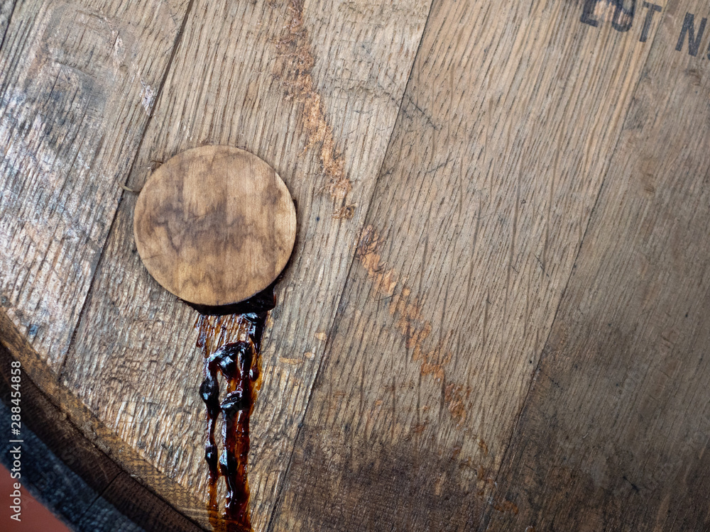 Wine barrel stopper with some leakage in storage of winery Stock Photo ...