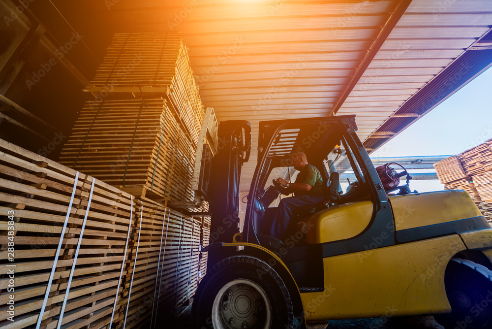 Forklift loader load lumber into a dry kiln. Wood drying in containers ...