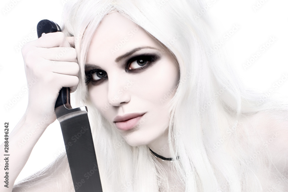 Beautiful and scaring witch woman in white with a knife and meat ...