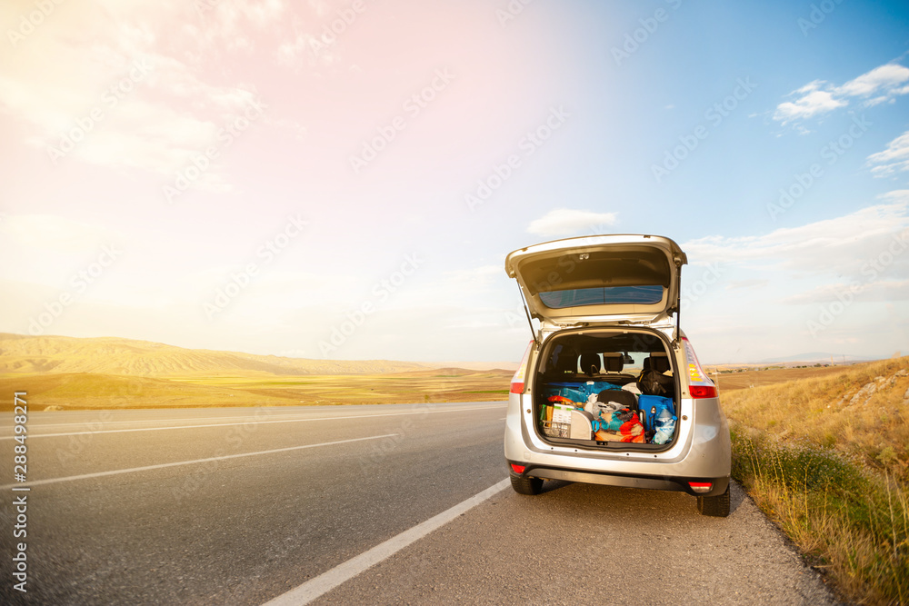 Car - minivan stands on the side of the road with an open trunk, a lot ...