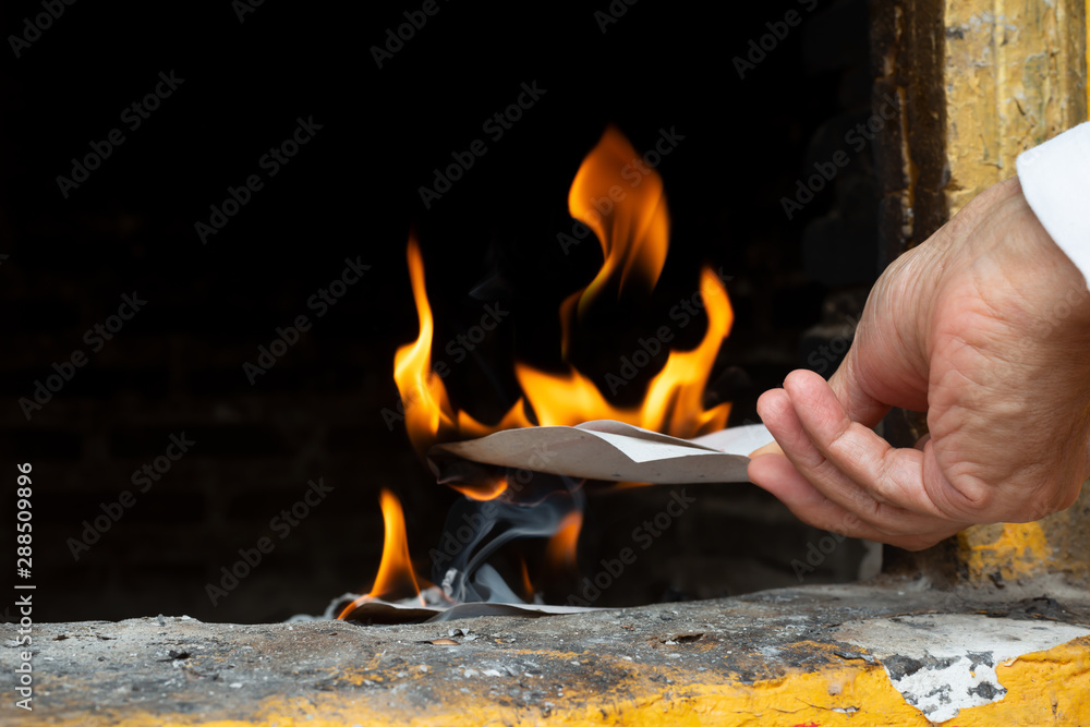 Faith and religious.Man hand burning paper gold and paper money in ...