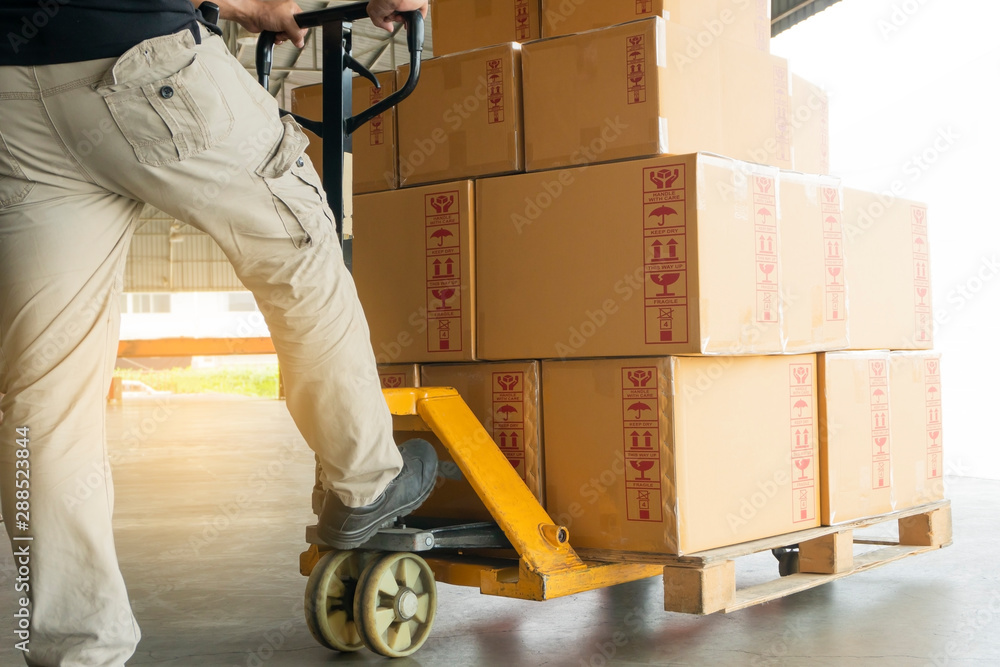 Workers Unloading Packaging Boxes on Pallet in Distribution Warehouse ...
