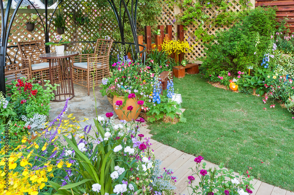 Lush landscaped backyard flower garden Stock Photo | Adobe Stock