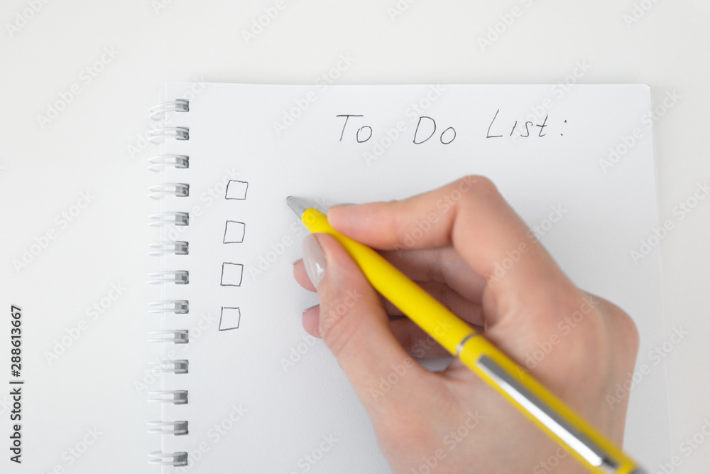 Woman writing to-do list yellow pen. Concept planning and self ...