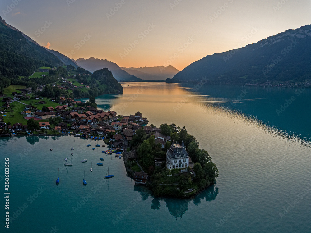 Overhead drone aerial view of The beautiful lake Brienz and village of ...