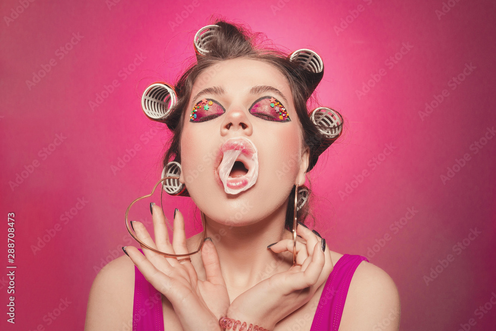 Cheeky girl with bubble gum posing on pink background in body, with ...