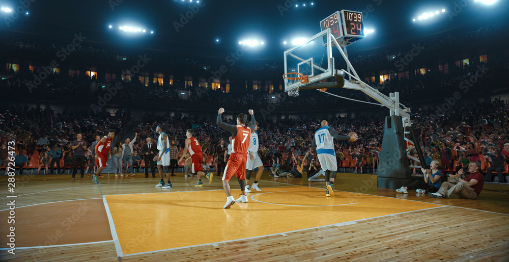 Basketball players on big professional arena during the game. Tense ...