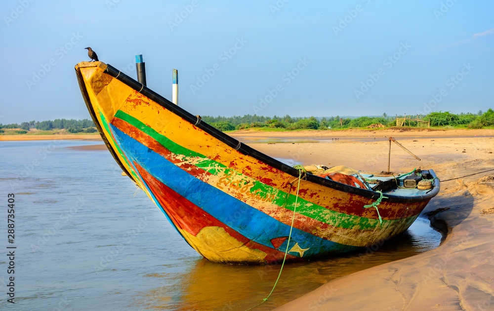 Traditional colorful fishing boat anchored at the confluence of ...