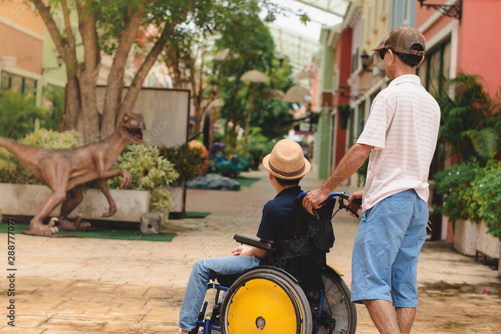 Father helping disabled child on the wheelchair,Dad needs his son ...