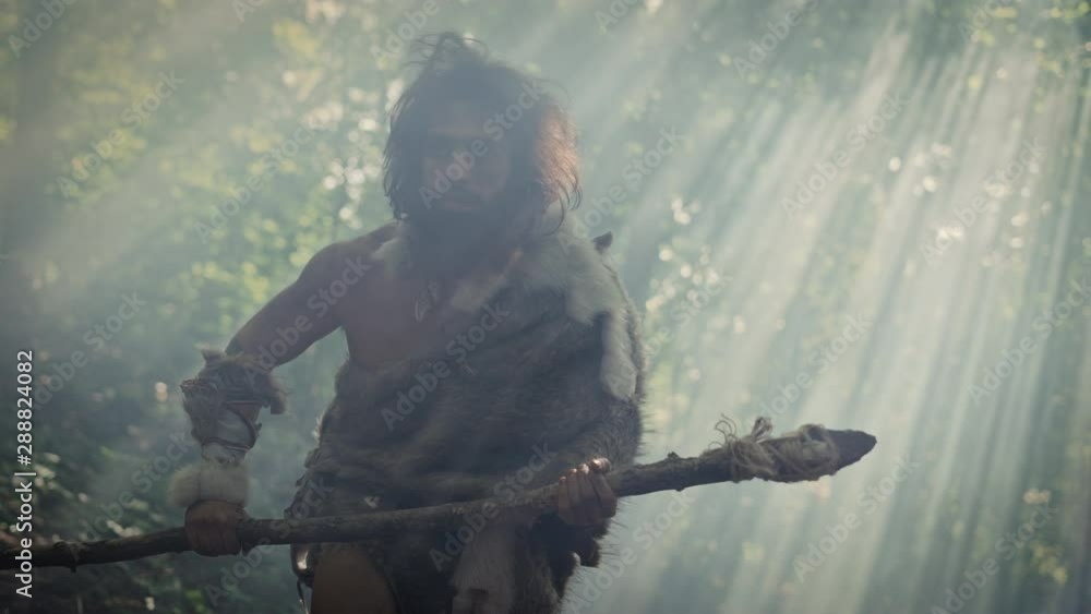 Portrait of Primeval Caveman Wearing Animal Skin and Fur Hunting with a ...