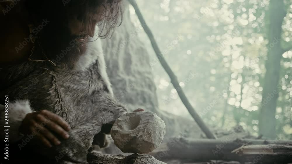 Primeval Caveman Wearing Animal Skin Hits Rock with Sharp Stone and ...