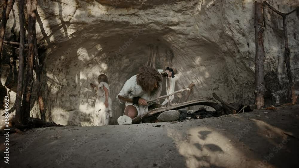 Primeval Caveman Wearing Animal Skin Trying to make a Fire with Bow ...