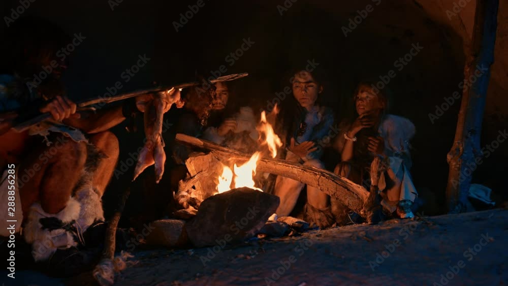 Neanderthal or Homo Sapiens Family Cooking Animal Meat over Bonfire and ...