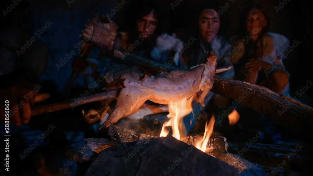 Neanderthal or Homo Sapiens Family Cooking Animal Meat over Bonfire and ...